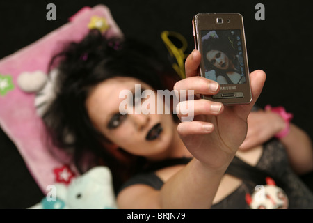 Woman taking a picture of herself with a phone Stock Photo - Alamy