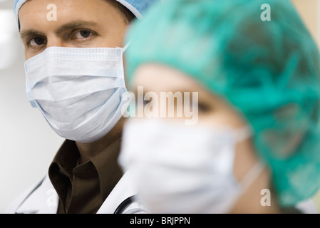 The faces of doctors surgeons in masks are a big plan, an operating ...