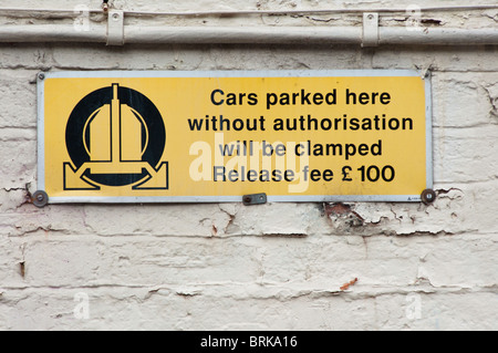 A wheel clamping warning sign on a wall in . Photo by Gordon Scammell ...