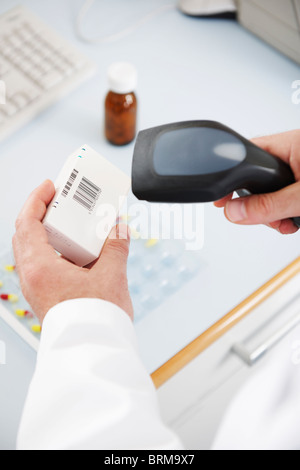 Pharmacist scanning barcode of medicine drug in a pharmacy drugstore ...