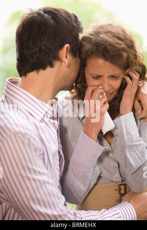 Couple hugging. Woman is sad and being consoled by his partner. Man ...