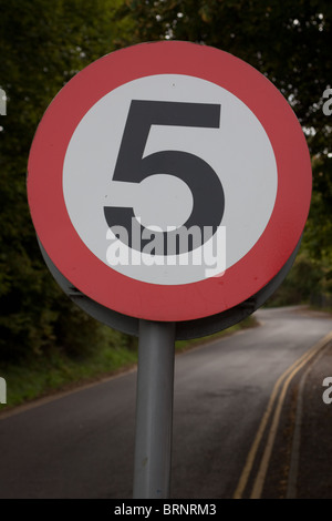 Five mile an hour speed limit with speed bumps sign in a residential ...