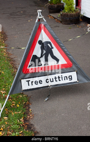 Tree cutting warning sign of men at work Stock Photo - Alamy