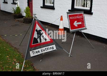 Tree cutting men at work warning signs, in the woods for walkers Stock ...