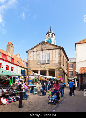 People shopping in Whitby market place and the Old Town Hall, North ...