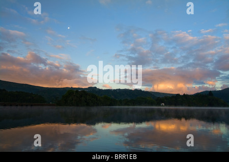 Mirror landscape of Sete Cidades Lake at sunrise, with the moon still ...