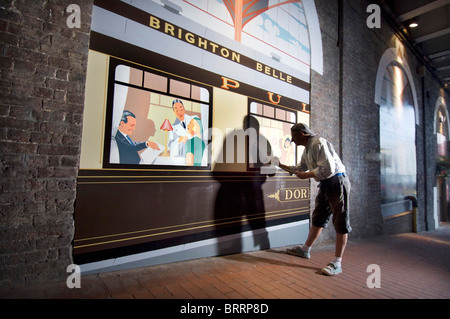 Signwriter Terry Smith paints an Art Deco style "Brighton Belle ...