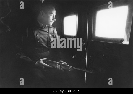 An RUC (Royal Ulster Constabulary) officer on patrol in the nationalist ...
