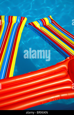 Colourful lilo floating in a swimming pool depicting summer holiday ...