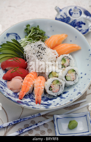 Vertical shot of sushi rolls in a row served on a white plate Stock ...