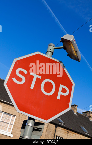Octagonal red stop sign at a UK road junction Stock Photo - Alamy