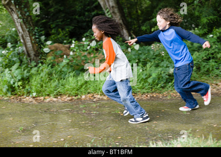 two happy boys playing tag game at park Stock Photo - Alamy