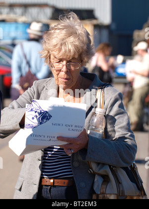 older woman eating fish and chips on a sunny day in the uk Stock Photo ...