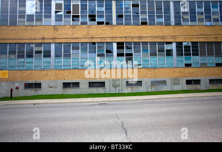 An old factory building with a lot of windows on the brick wall in ...