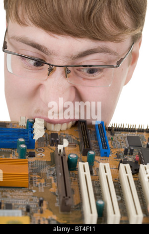Guy bites an old circuit board Stock Photo - Alamy