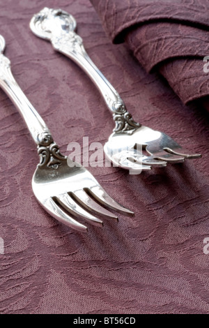 Closeup of two silver forks and one spoon on a black background Stock ...