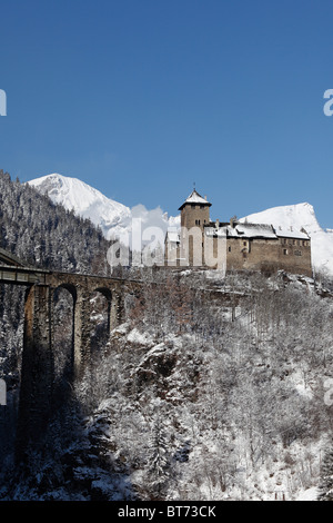 Schloss Wiesberg Castle with bridge over the Trisanna river. Mountain ...