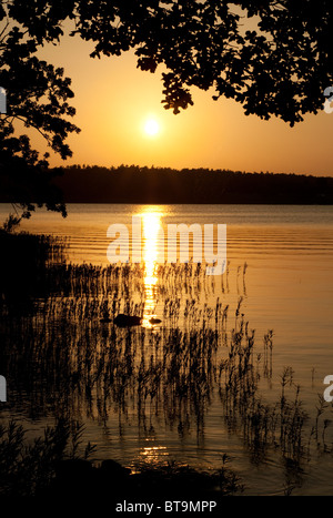 colorful sunset over peaceful lake Stock Photo - Alamy