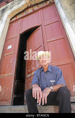Smiling mature man sitting in sun lounger, solar plant Stock Photo - Alamy