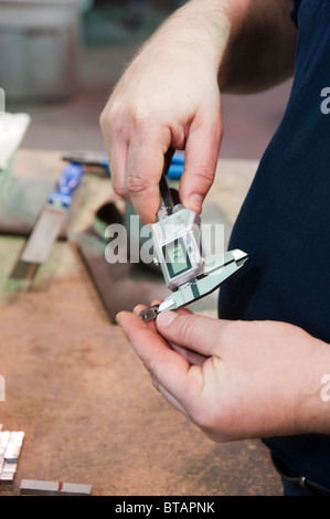 Metal tooling shop floor Technician uses a gauge for quality control on ...