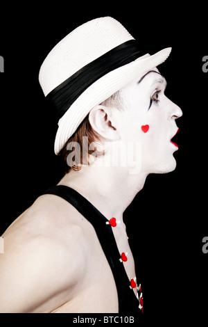 Pantomimes in white hat on black background Stock Photo - Alamy
