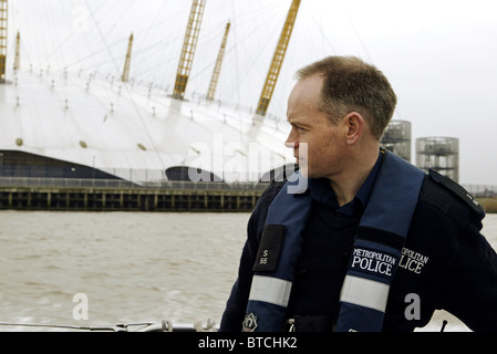 Officer from Metropolitan Police Marine Policing unit on the river ...