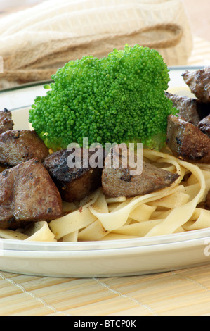 liver goulash on pasta with organic carrot Stock Photo - Alamy