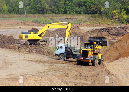 sandpit - excavator dump tipper loads of sand Stock Photo - Alamy