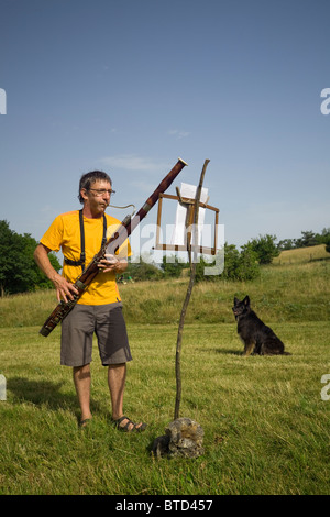 A man playing the bassoon in open air (Auvergne - France). Joueur de ...