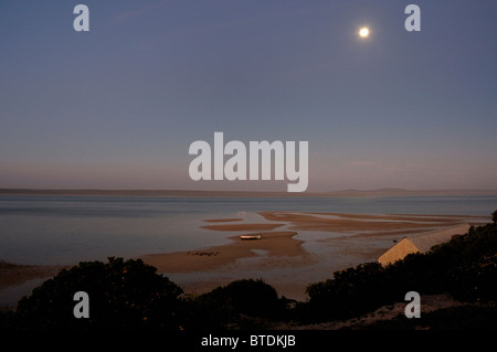 Churchaven lagoon at sunset with the full moon Stock Photo - Alamy