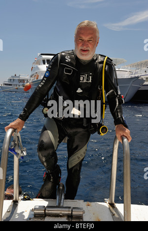 Scuba diver climbing boat ladder after a dive MV Sea Spirit Maldives ...