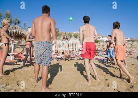 Tourists playing on volley ball court next to the beach road in Roda ...