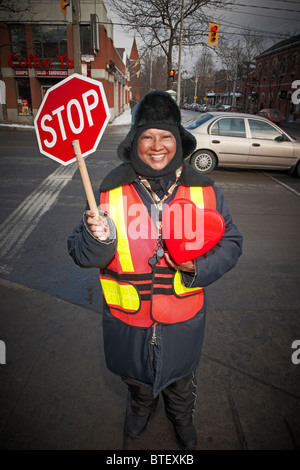 Female crossing guard with stop sign Stock Photo - Alamy