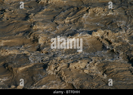 fast brown rapid flood water in river Stock Photo - Alamy