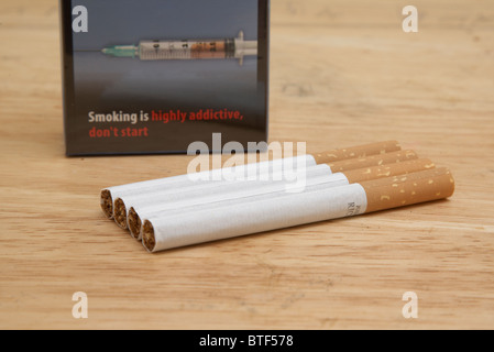 Cigarettes sitting next to each other in a line Stock Photo - Alamy