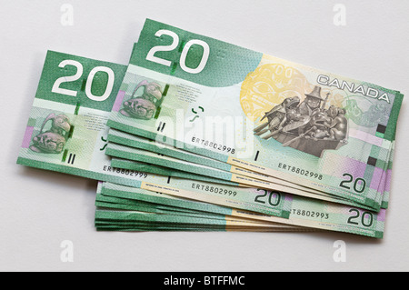 Several twenty dollar cash bills are laid out in neat stack for payment ...