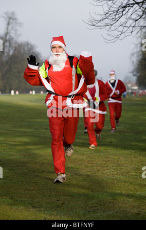 Happy Santa Claus finishing a race on a snow Stock Photo - Alamy
