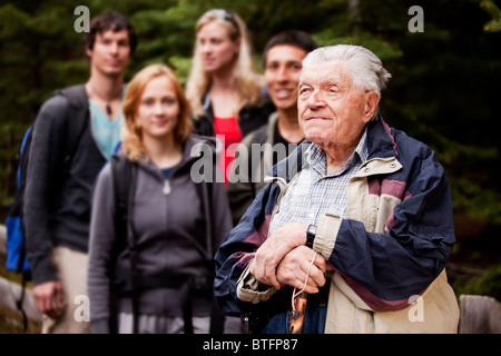 An elderly man giving a tour for a young group of people Stock Photo ...