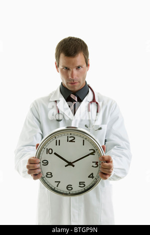 Doctor with ticking clock and Serious Male Patient Stock Photo - Alamy