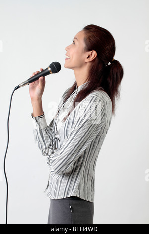 Office lady takes microphone and sings song Stock Photo - Alamy