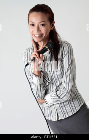 Office lady takes microphone and sings song Stock Photo - Alamy
