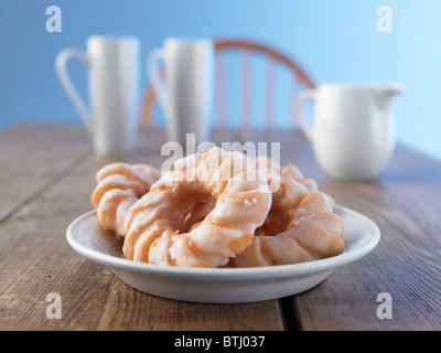Cruller with glazed icing. Deep fried choux pastry. Traditional german ...