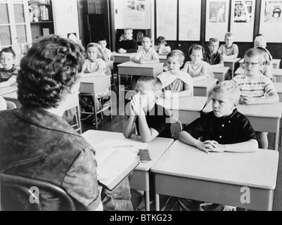 1960s, historical, children in a classroom , sitting at wooden desks ...
