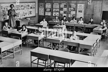 1960s, historical, children in a classroom , sitting at wooden desks ...