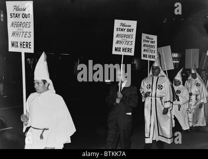 Ku Klux Klan members, in hooded white robes hoods, picket an Stock ...