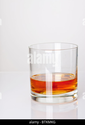 Whiskey neat in shot glass on white background Stock Photo - Alamy
