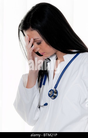Female doctor feeling overwhelmed at work, sitting on stairs ...