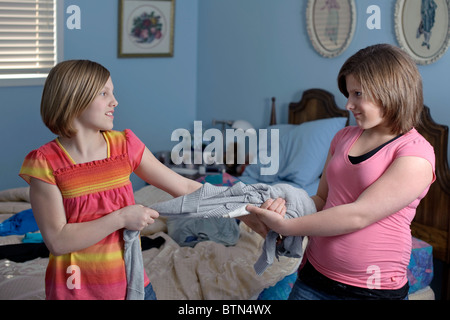 two young sisters fighting over some clothing Stock Photo - Alamy