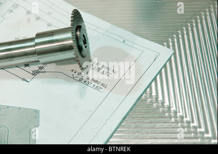 Metal tooling shop floor concept with CAD blueprint and micrometer ...