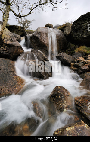 Waterfalls on Afon (River) Cwm Llan showing old slate quarry building ...